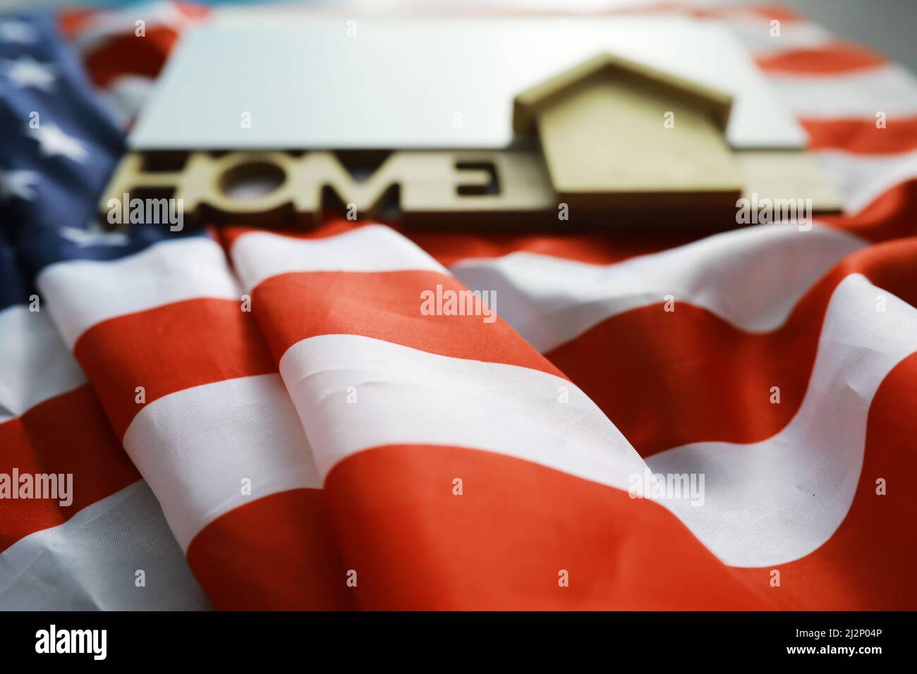 House symbol on American flag. Mortgage credit lending. Housing safety ...