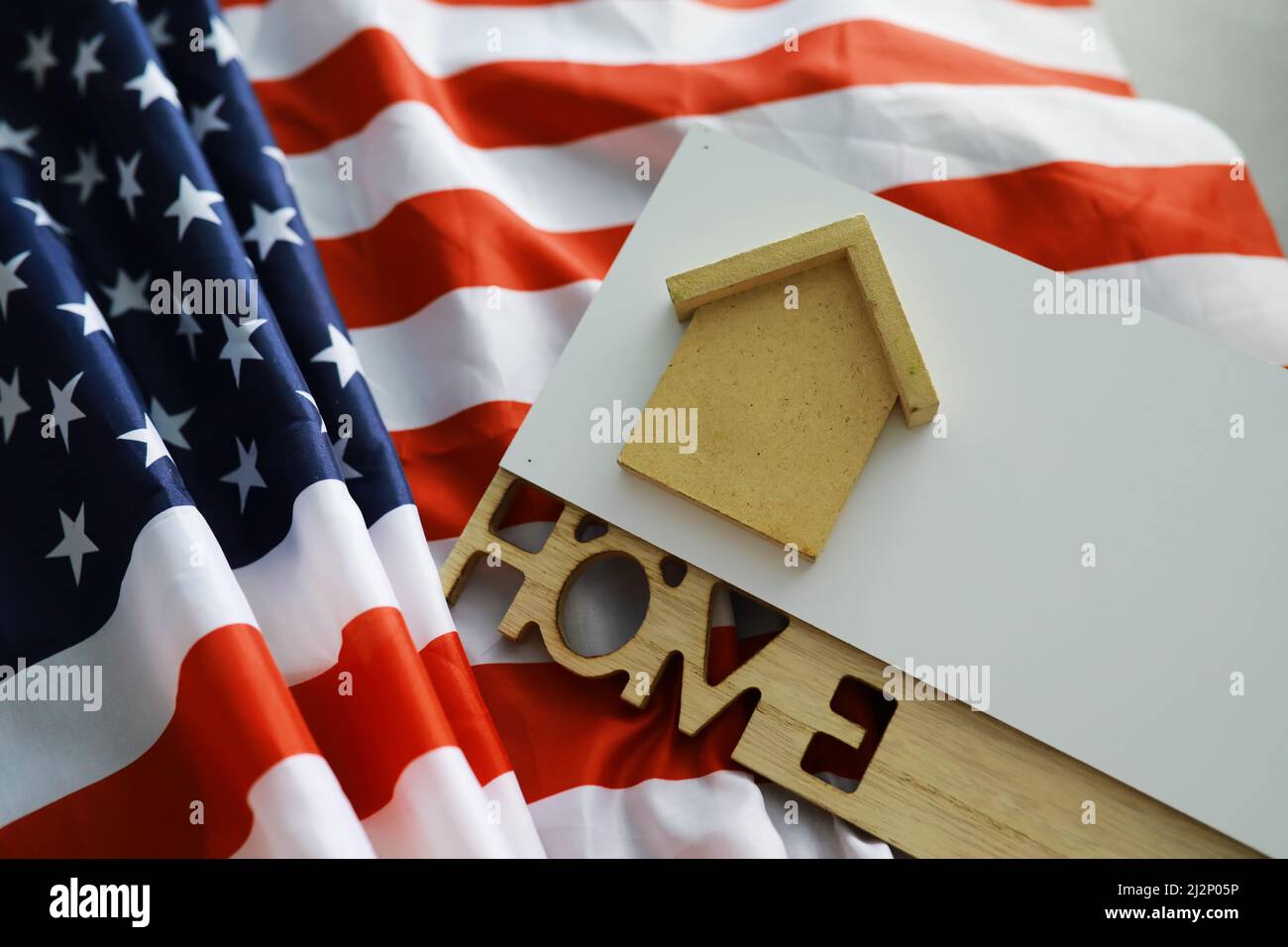 House symbol on American flag. Mortgage credit lending. Housing safety ...