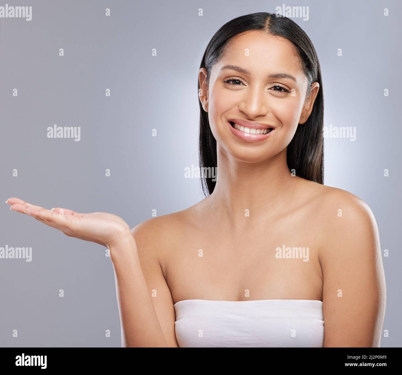 What do I have here.... Studio shot of a beautiful young woman holding ...