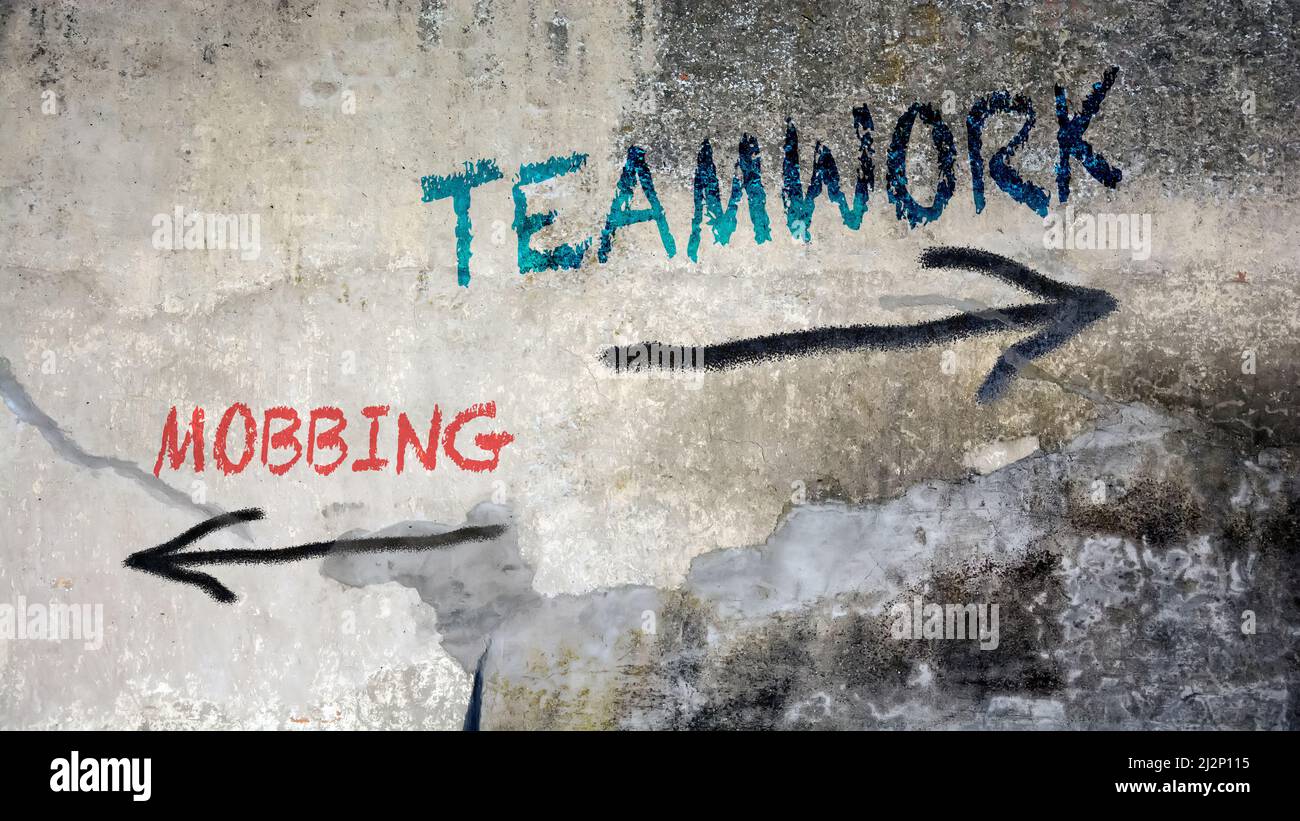 Street Sign the Direction Way to Teamwork versus Mobbing Stock Photo ...