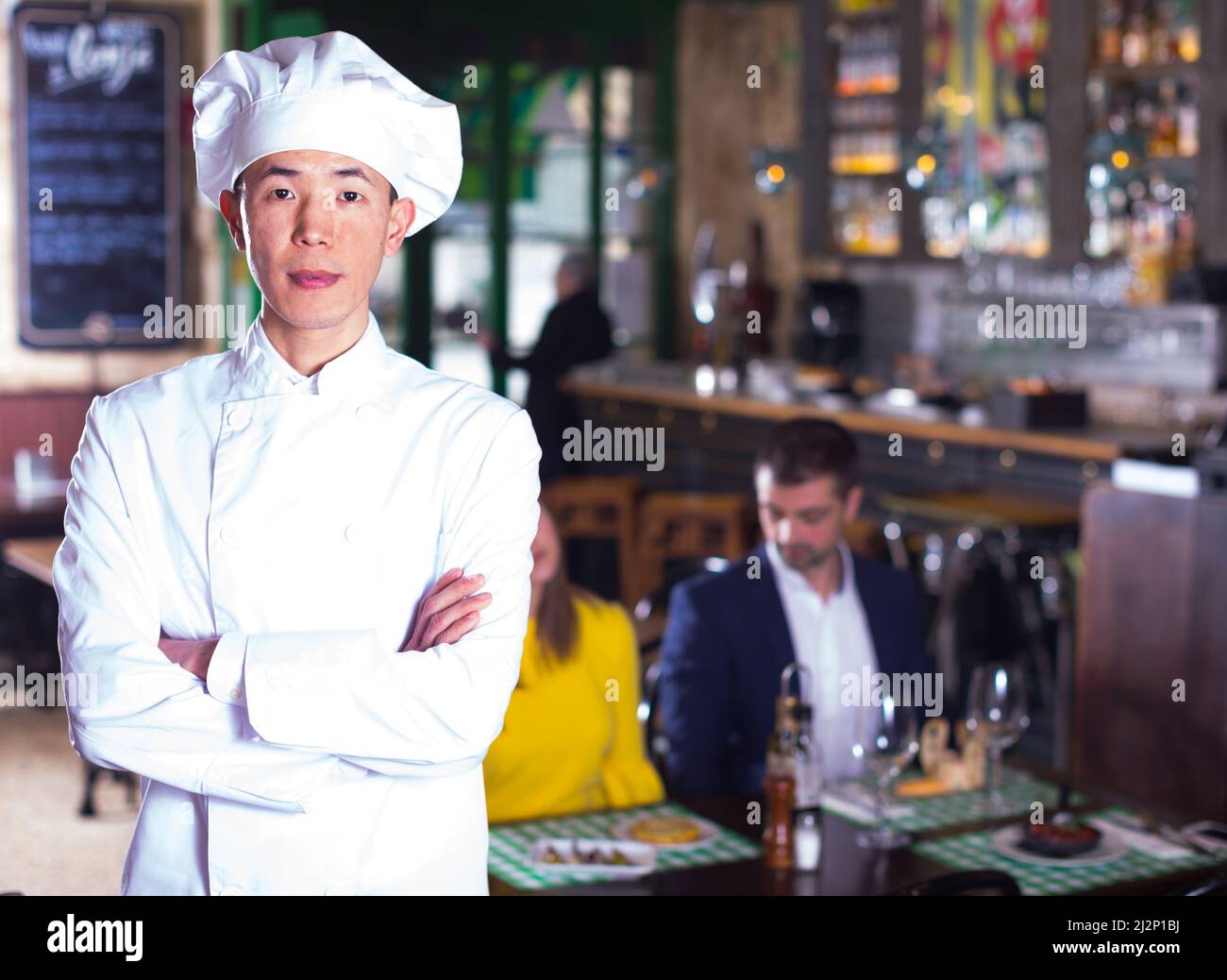 Smiling chef cook is posing in hall Stock Photo - Alamy