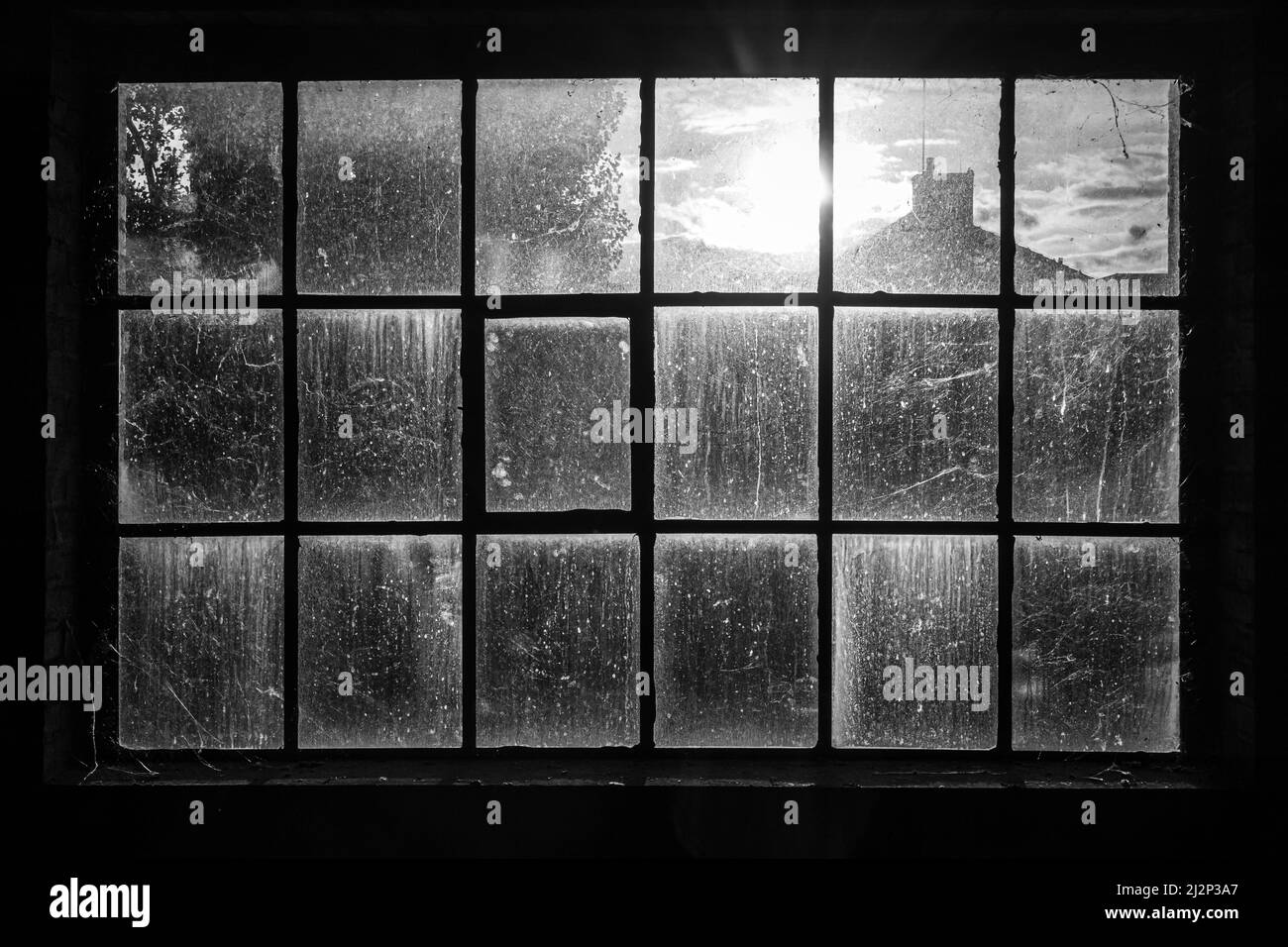 Dirty window in abandoned factory with sun shining through Stock Photo ...
