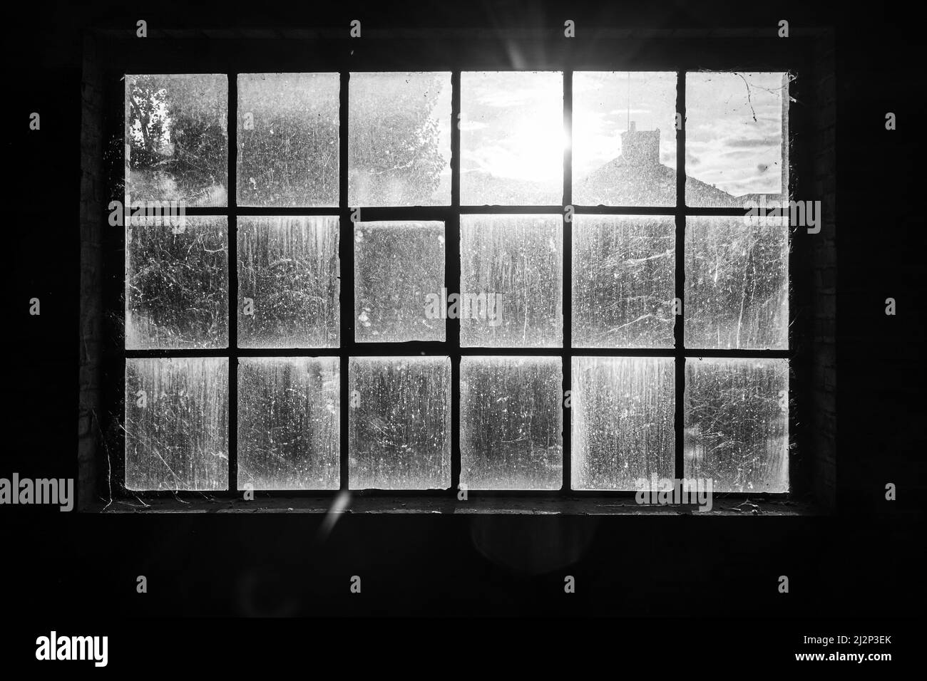Dirty window in abandoned factory with sun shining through Stock Photo ...