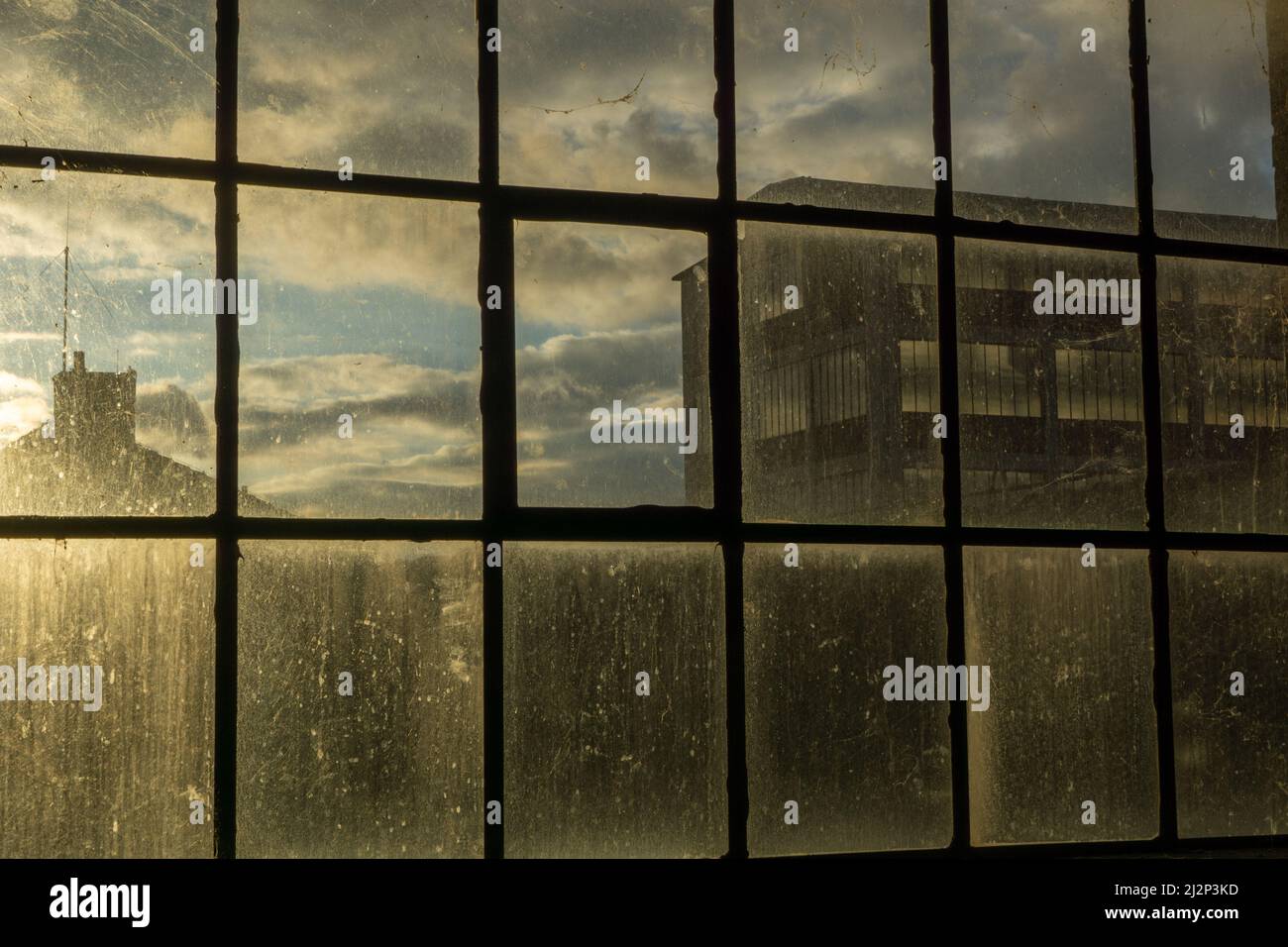 Dirty window in abandoned factory with sun shining through Stock Photo ...