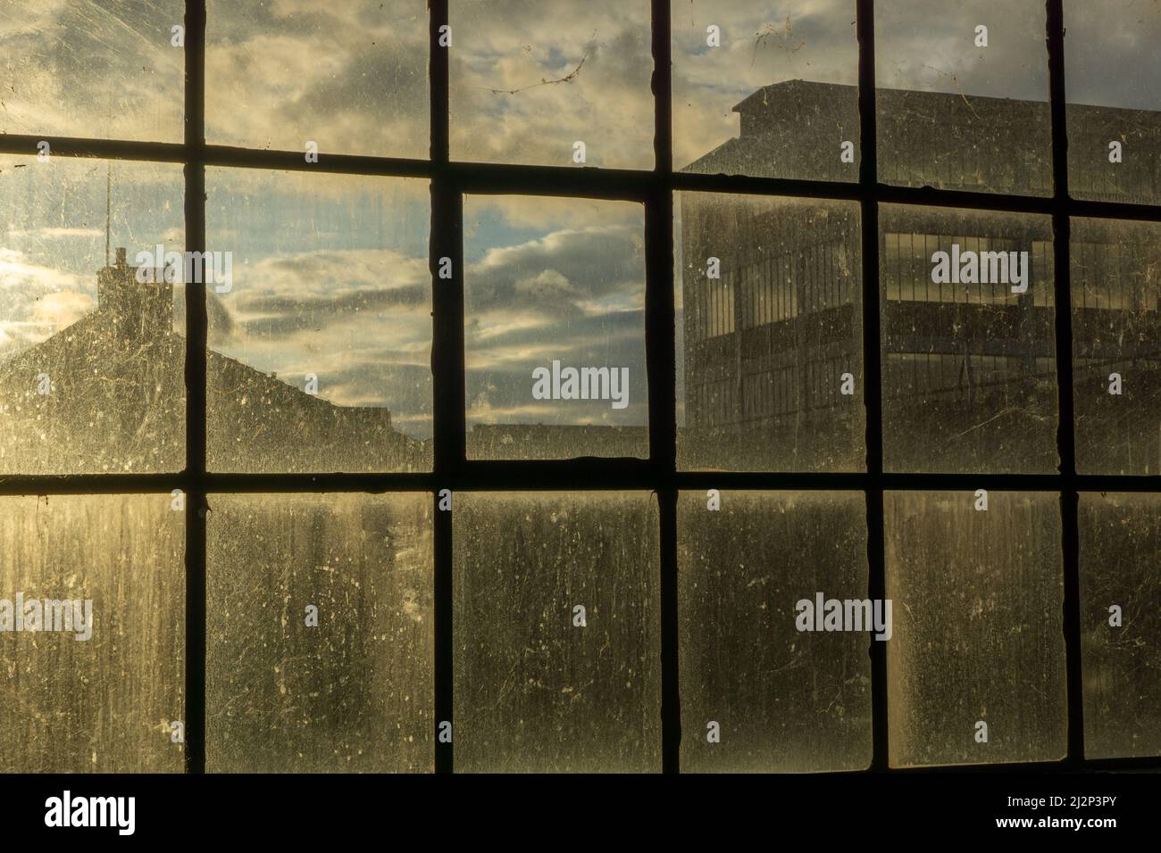 Dirty window in abandoned factory with sun shining through Stock Photo ...