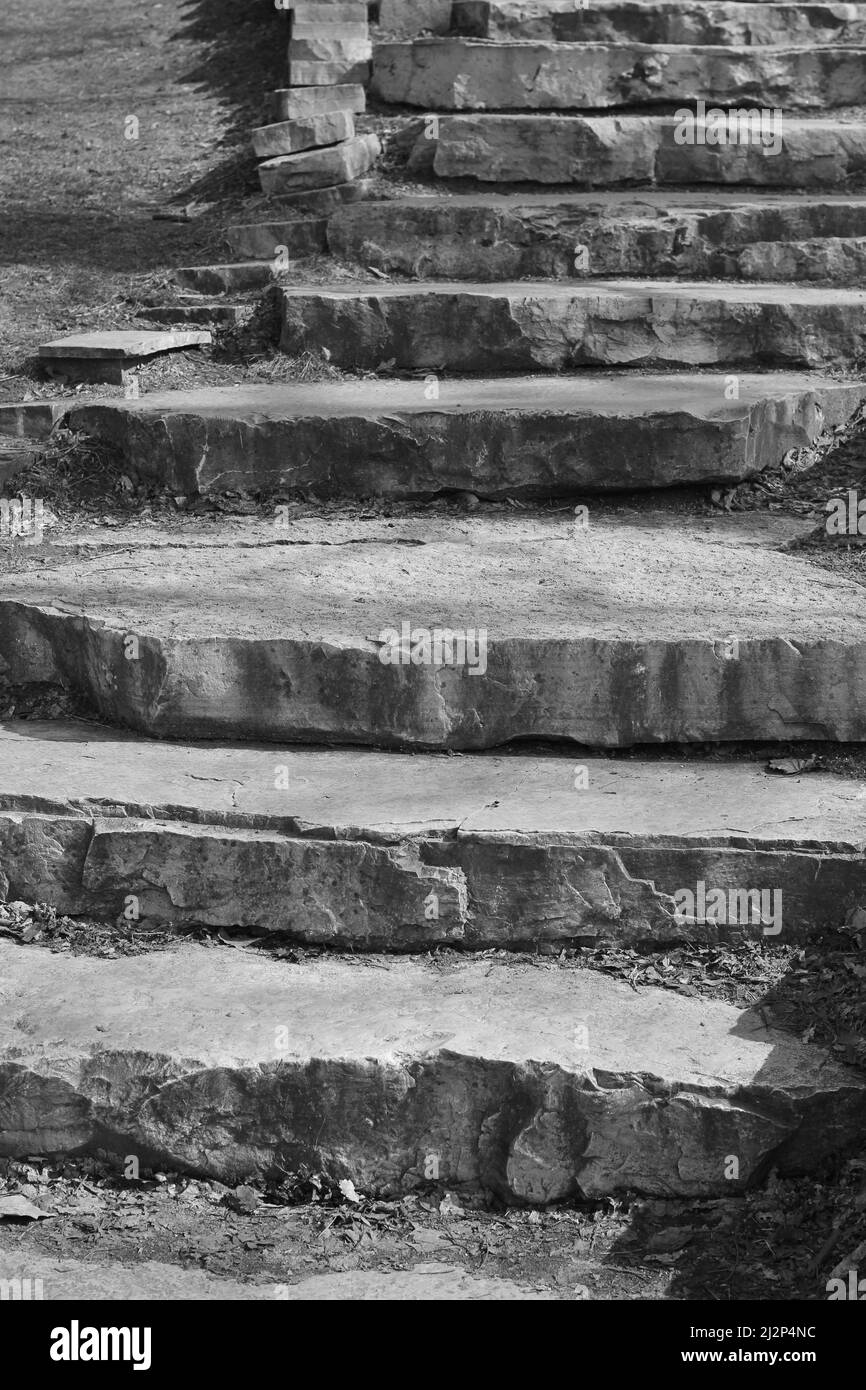The random pattern of vintage limestone stairs in the park in black and ...