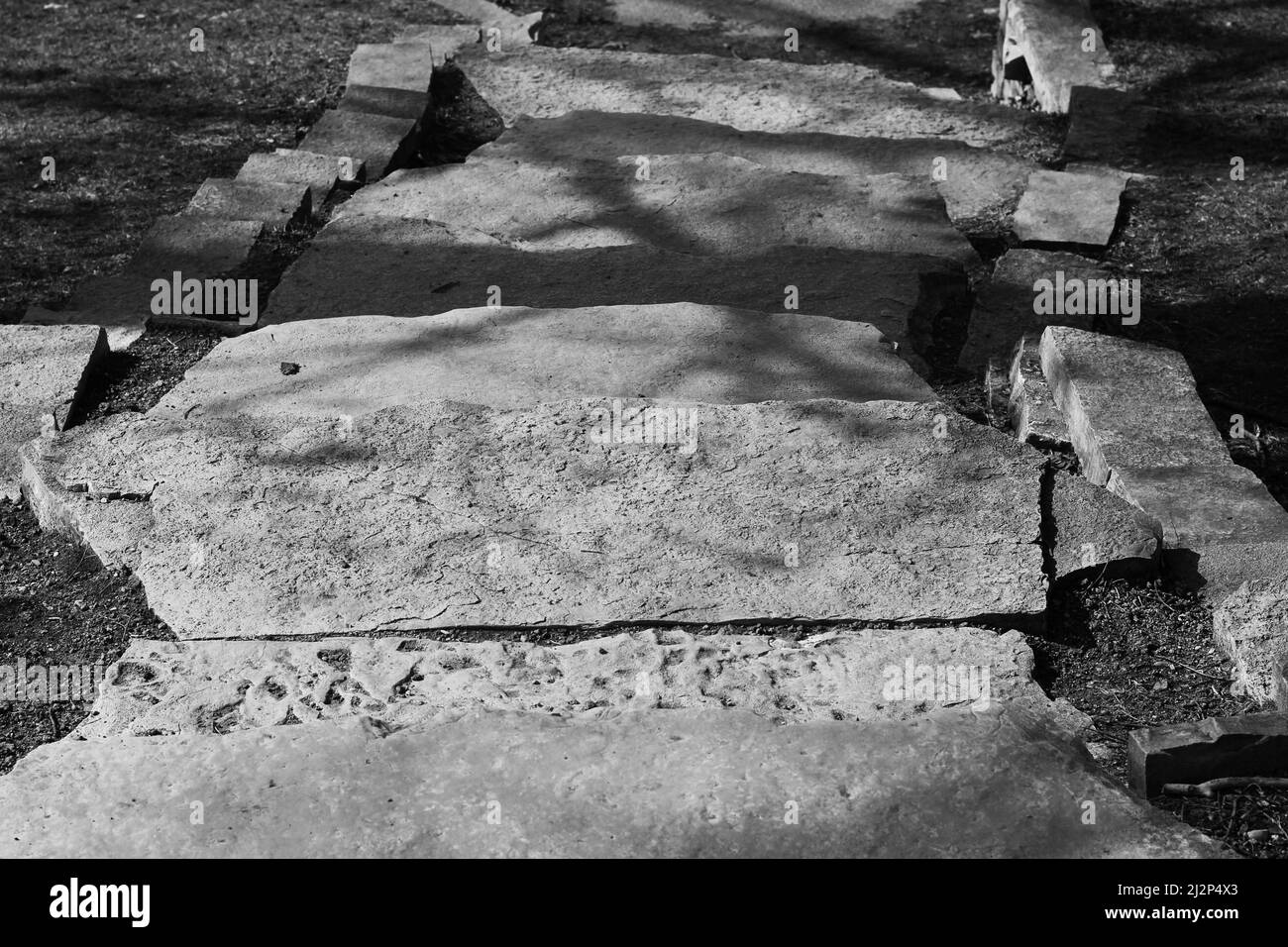 The random pattern of vintage limestone stairs in the park in black and ...