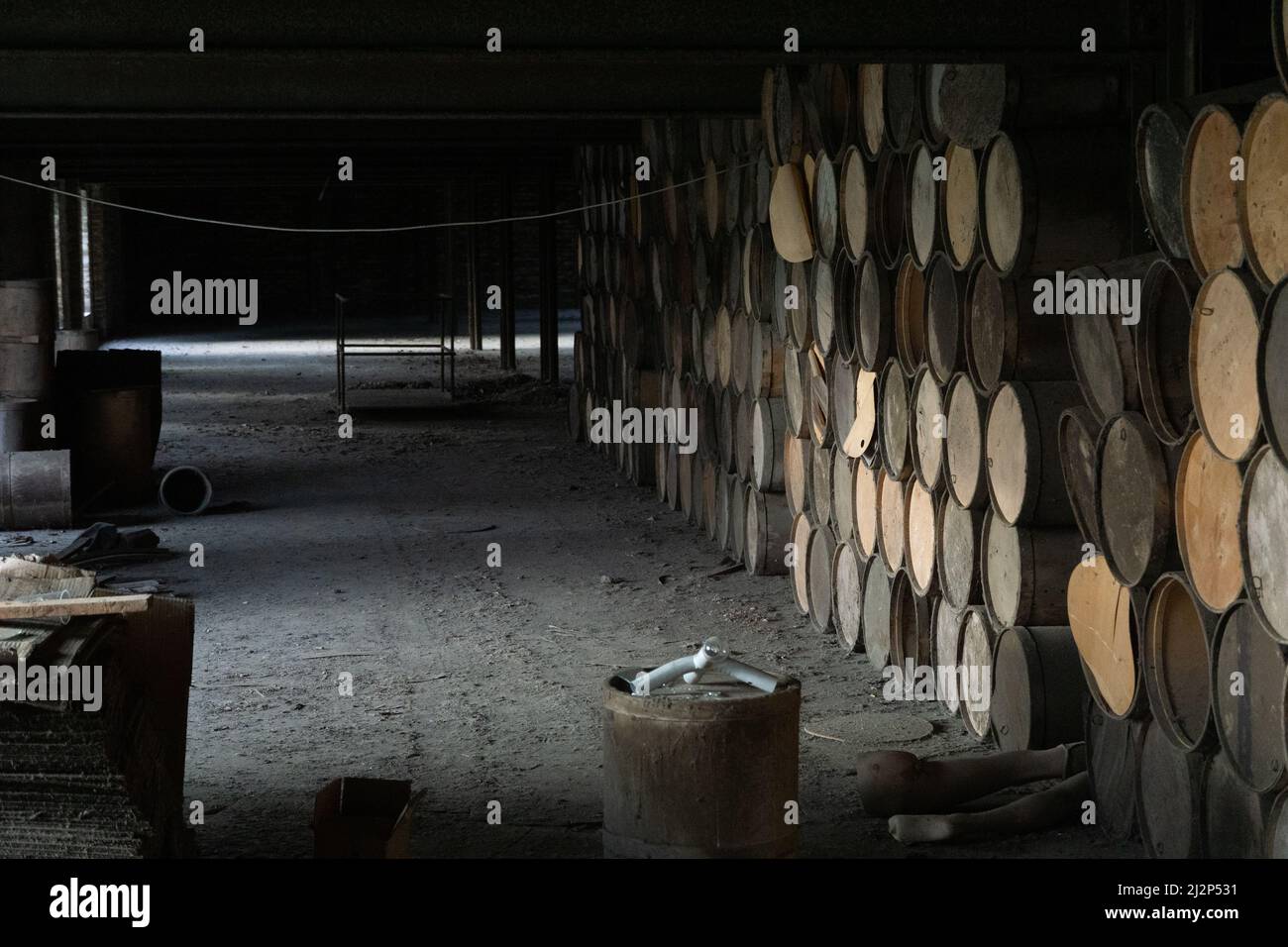wooden barrels stacked in old abandoned industry building Stock Photo ...