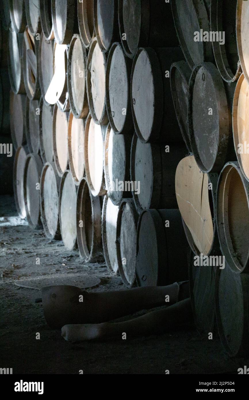 wooden barrels stacked in old abandoned industry building Stock Photo ...