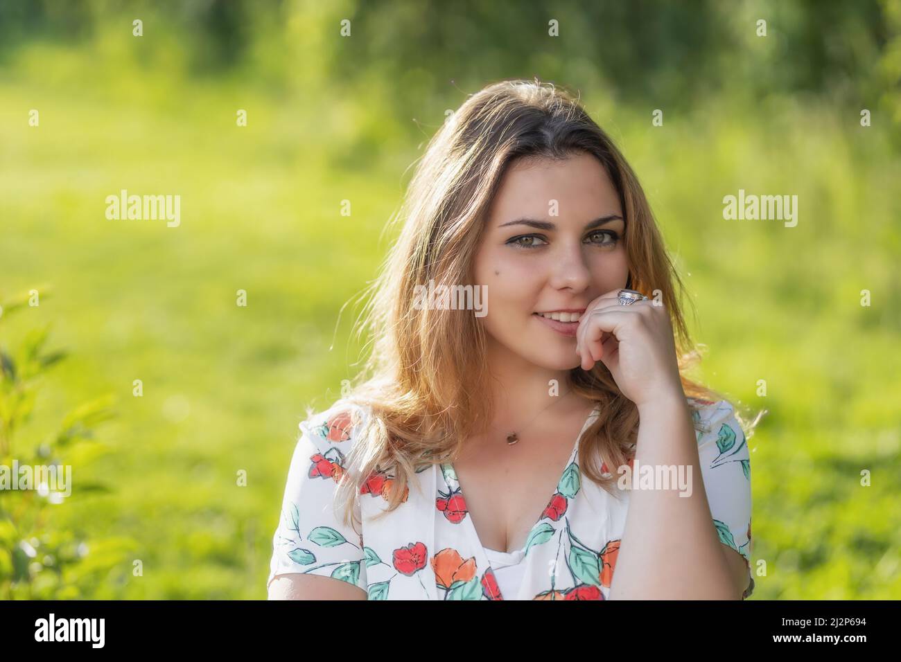 Atractive beautiful young woman with is posing outdoors. Horizontally ...