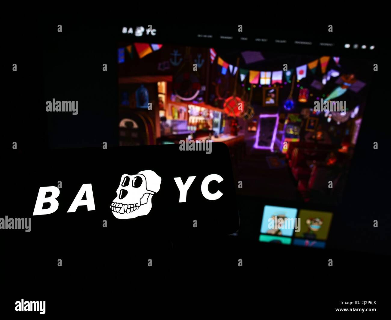 Person holding smartphone with logo of Bored Ape Yacht Club (BAYC, Yuga ...