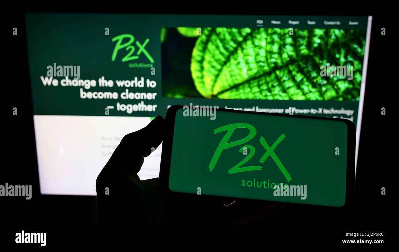 Person holding mobile phone with logo of Finnish energy company P2X ...