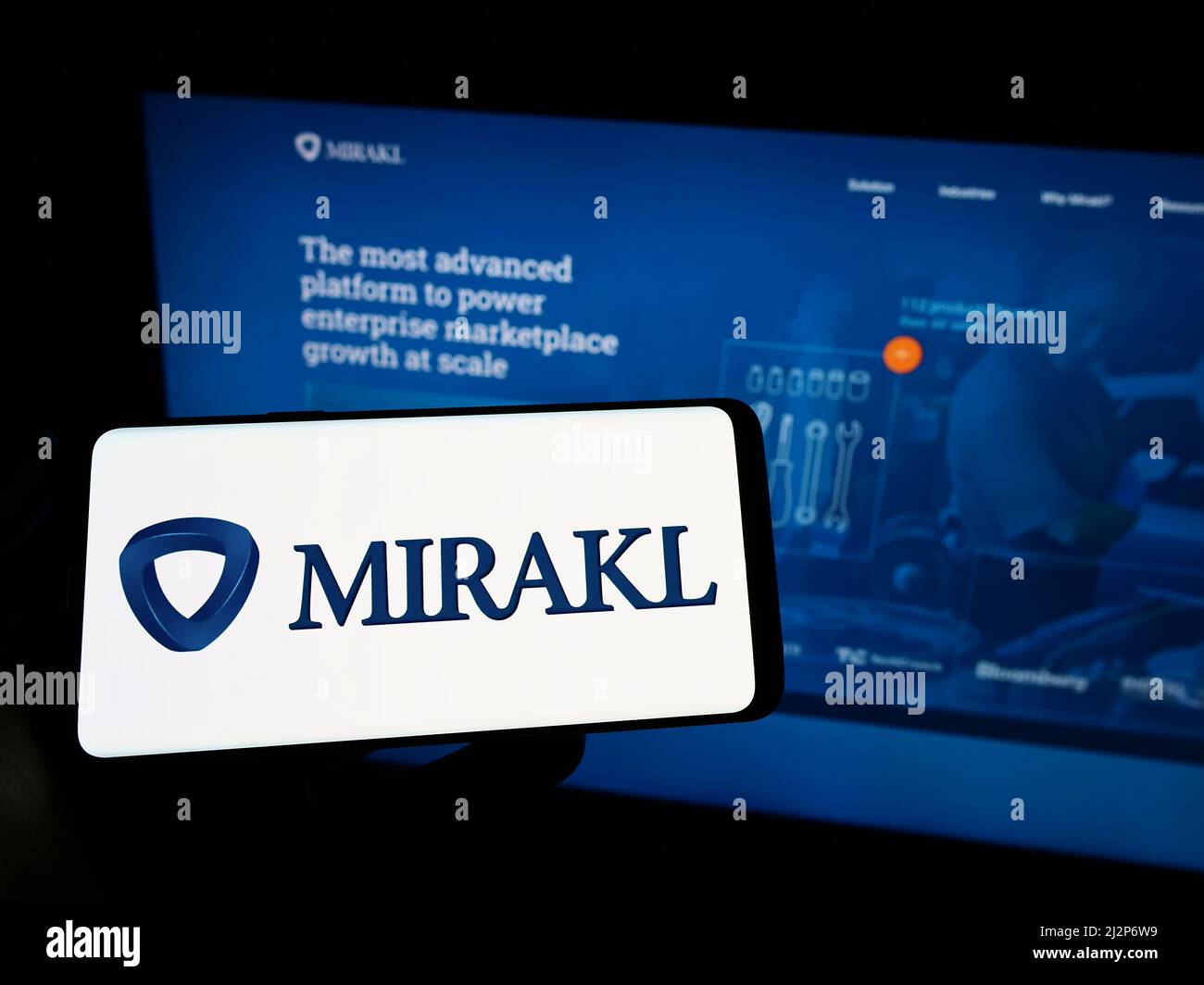 Person holding mobile phone with logo of French e-commerce software ...