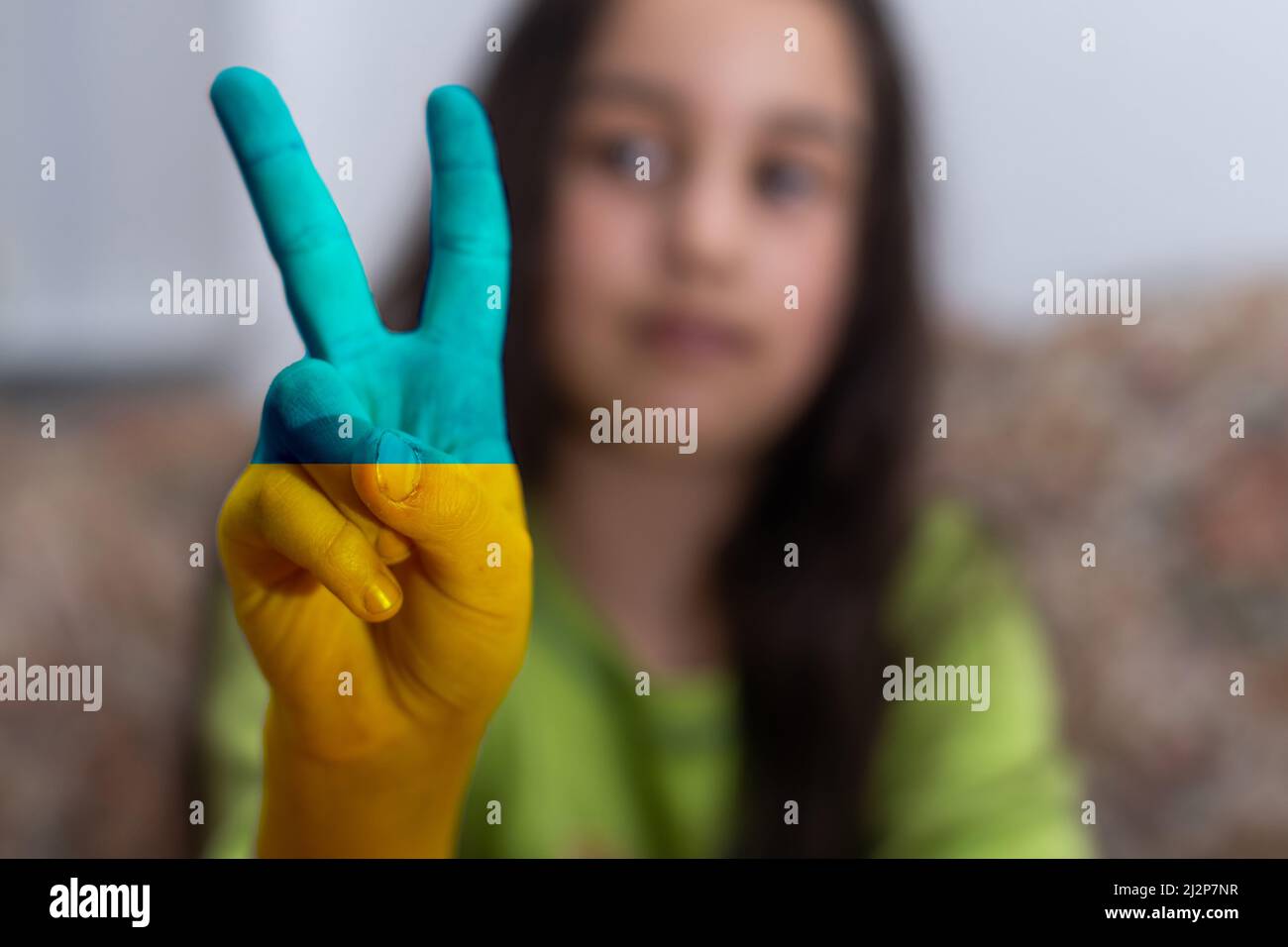 peace hand kid Female and male hands painted in Ukraine flag colors ...