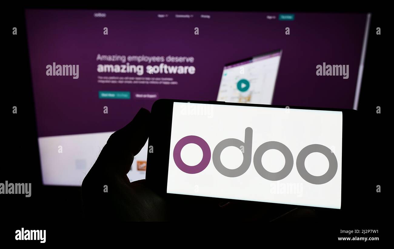 Person holding smartphone with logo of French software company Odoo SA ...