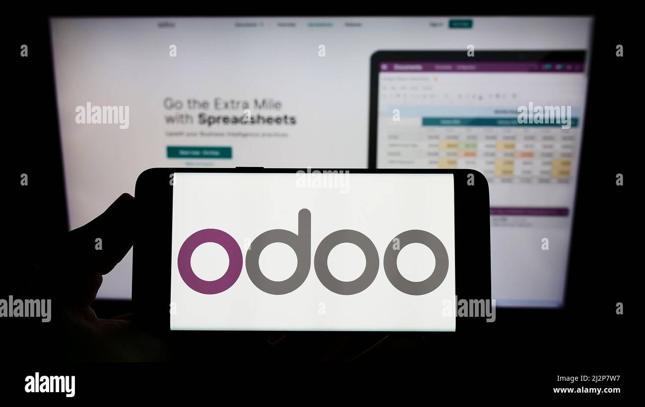 Person holding mobile phone with logo of French software company Odoo ...