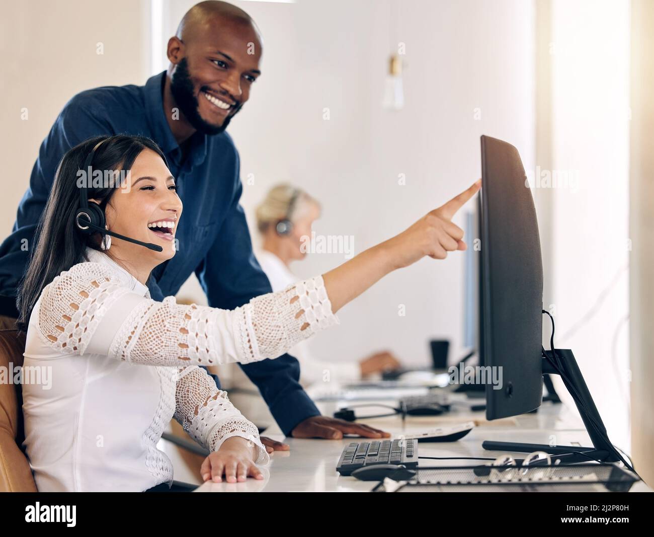 Identifying and addressing customer needs. Shot of two call centre ...