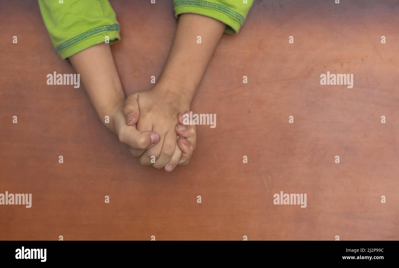 Child's hands folded together in prayer Stock Photo - Alamy
