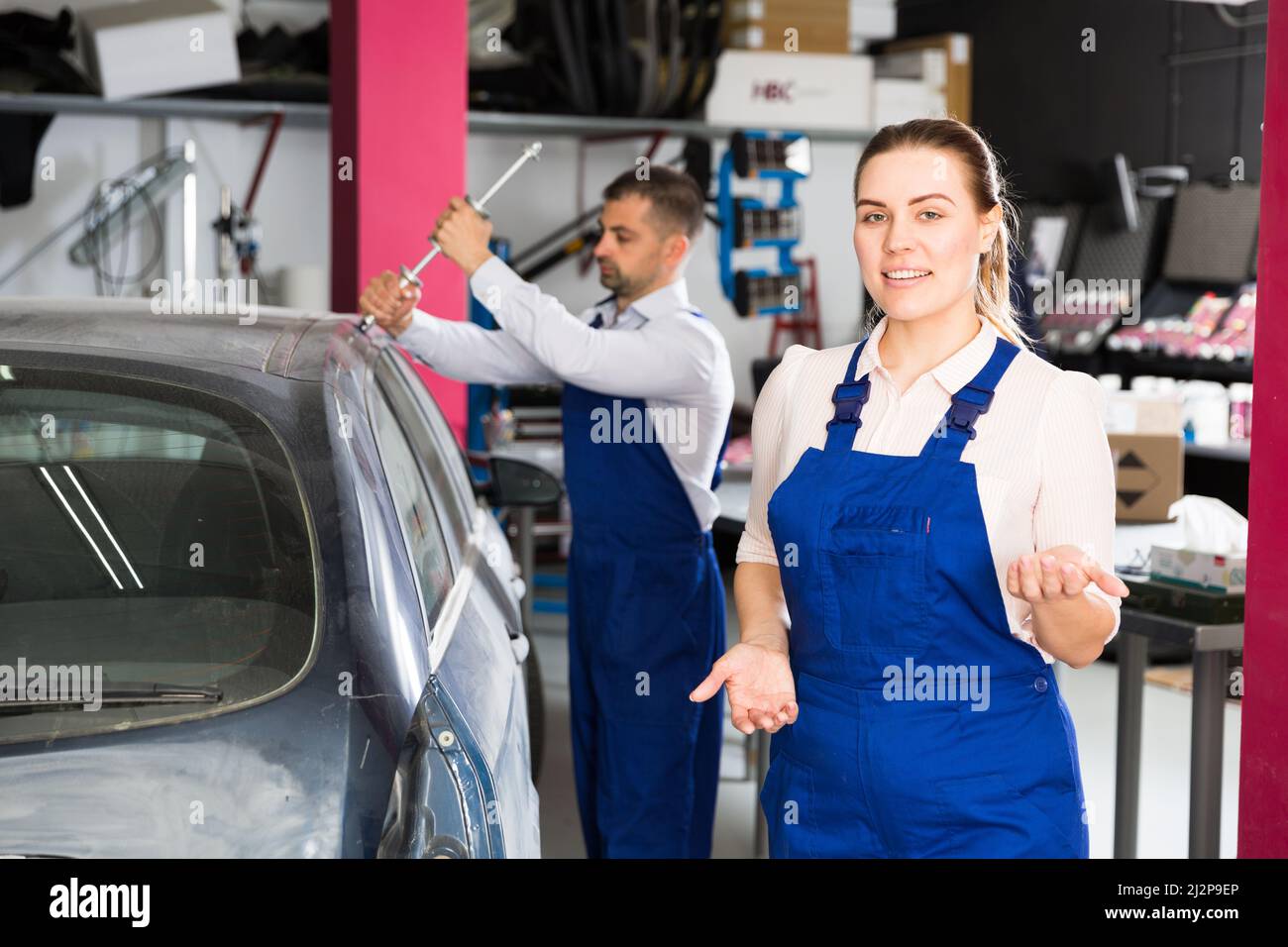 Female mechanic welcoming in car workshop Stock Photo - Alamy