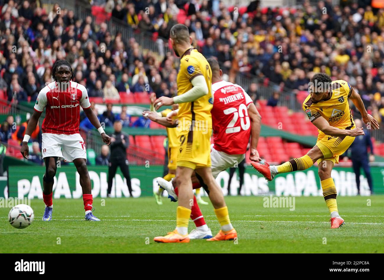 Sutton United's Donovan Wilson (right) scores their side's first goal ...