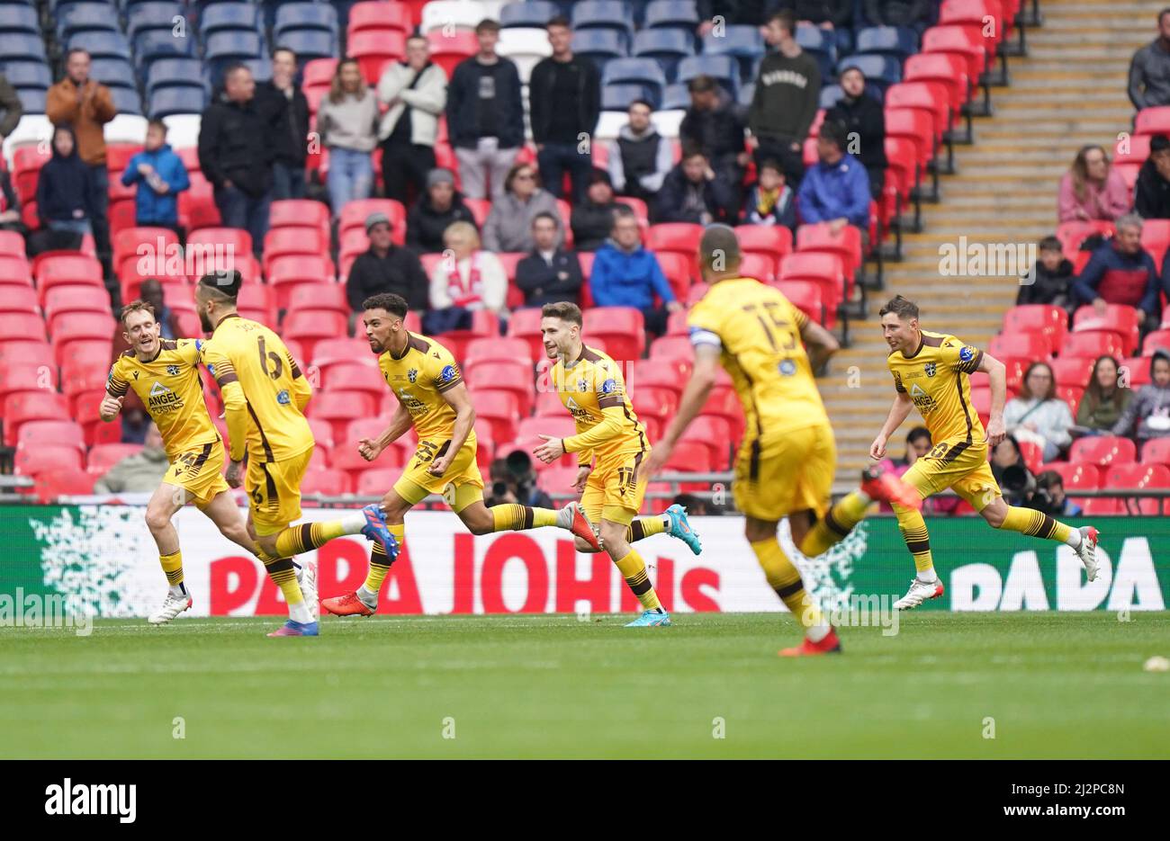 Sutton United's Donovan Wilson (third left) celebrates scoring their ...
