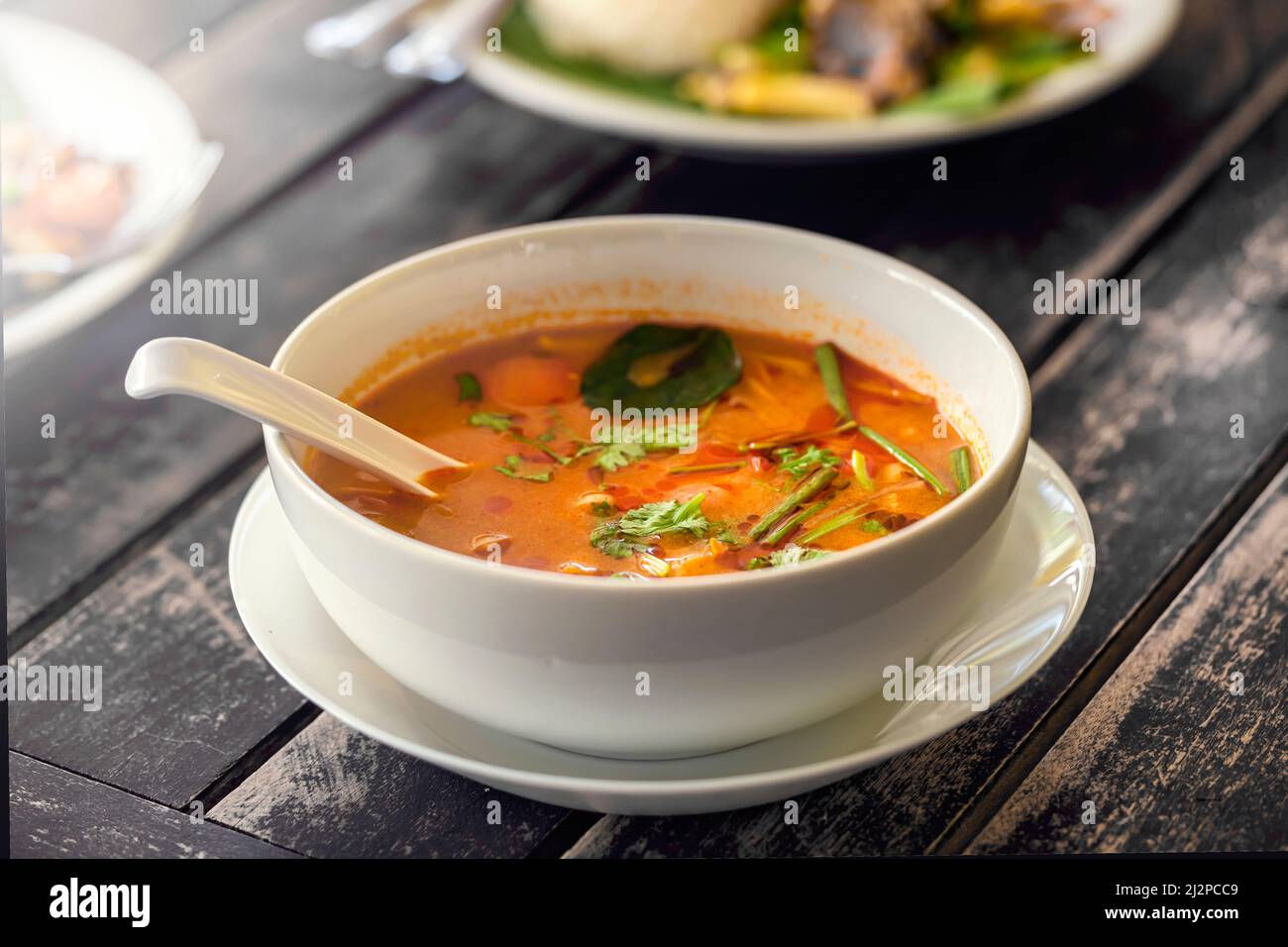 Tom Yam traditional soup with seafood, mushrooms, coconut milk and hot ...