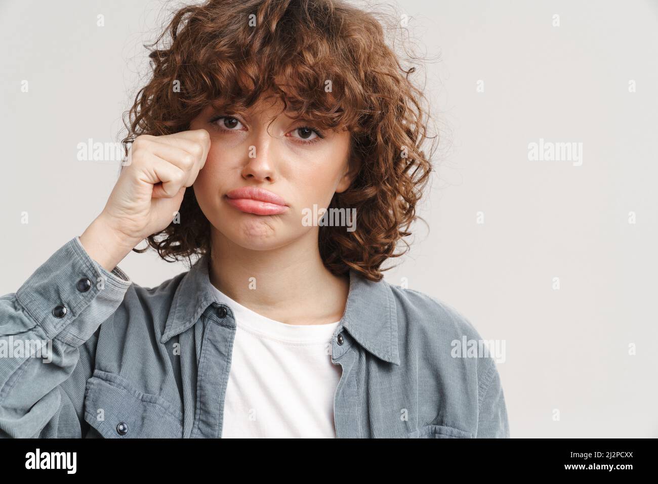Unhappy ginger woman in shirt crying and looking at camera isolated ...