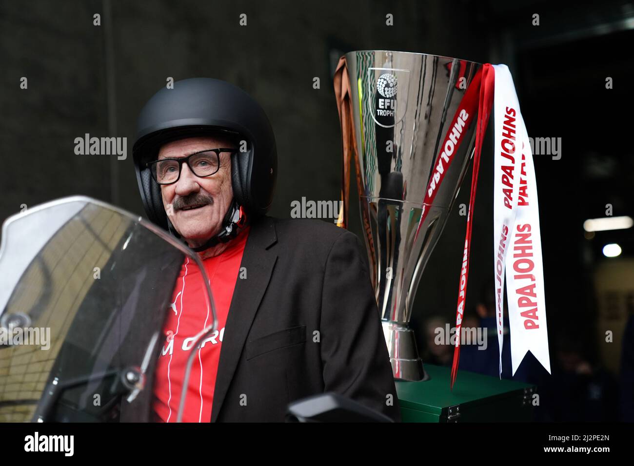 Paul Chuckle delivers the trophy on a moped before the Papa John's ...