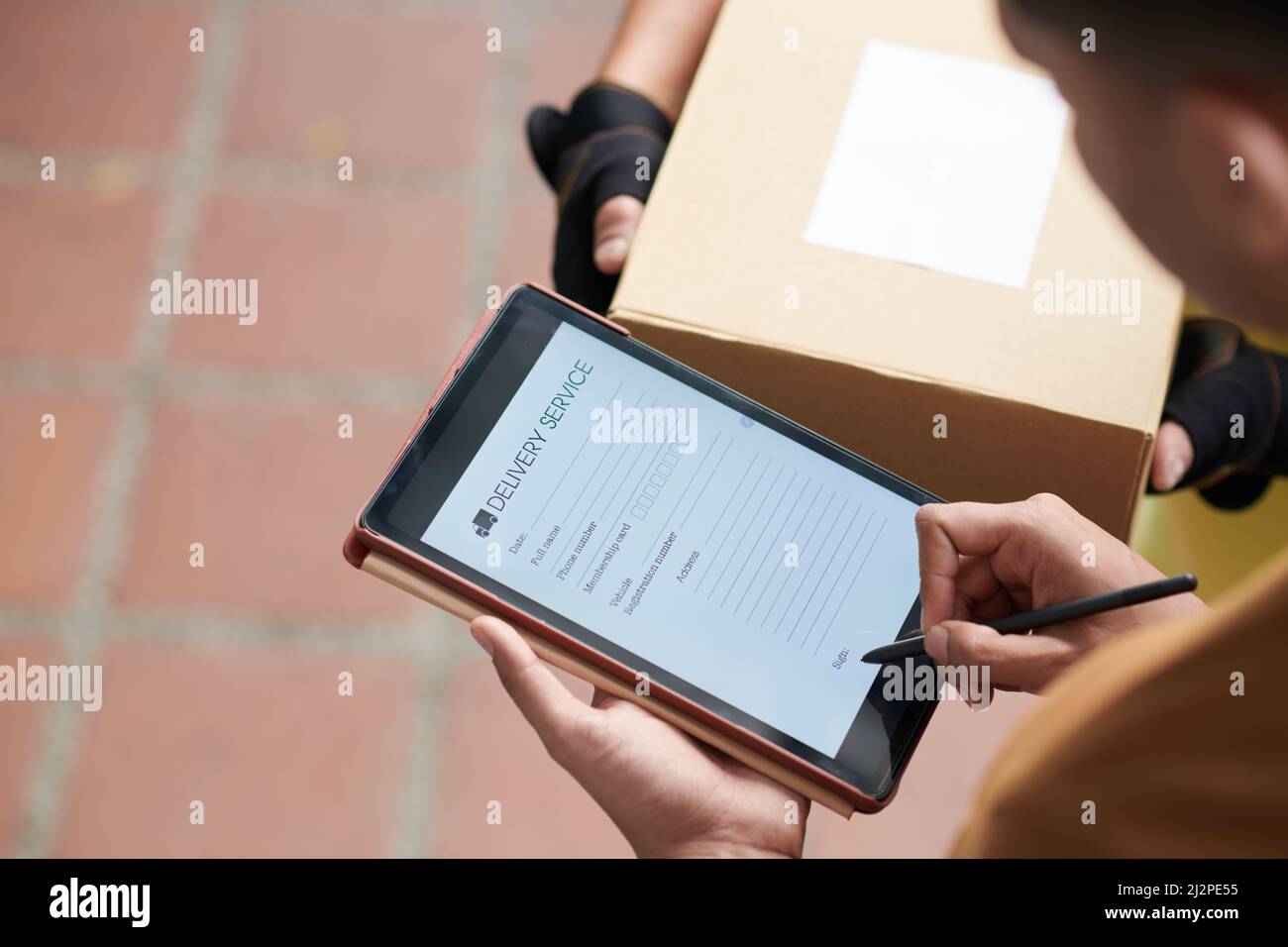 Customer signing delivery service document on tablet computer after ...