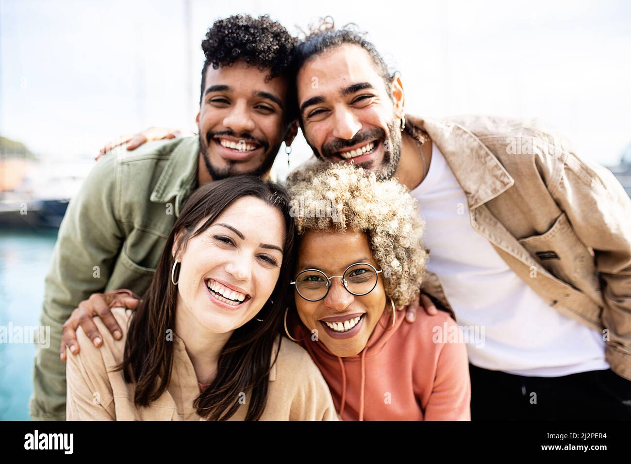Group portrait of four multiracial united friends outdoors Stock Photo ...