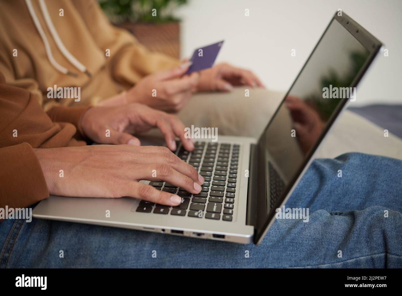 Closeup image of man making order in online store when girlfriend ...
