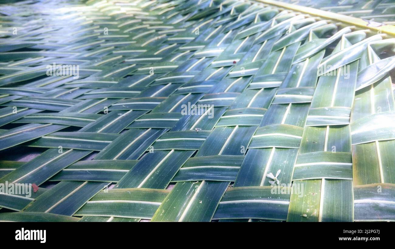 Close-up of a coconut leaf mat showcasing intricate weaving, natural ...
