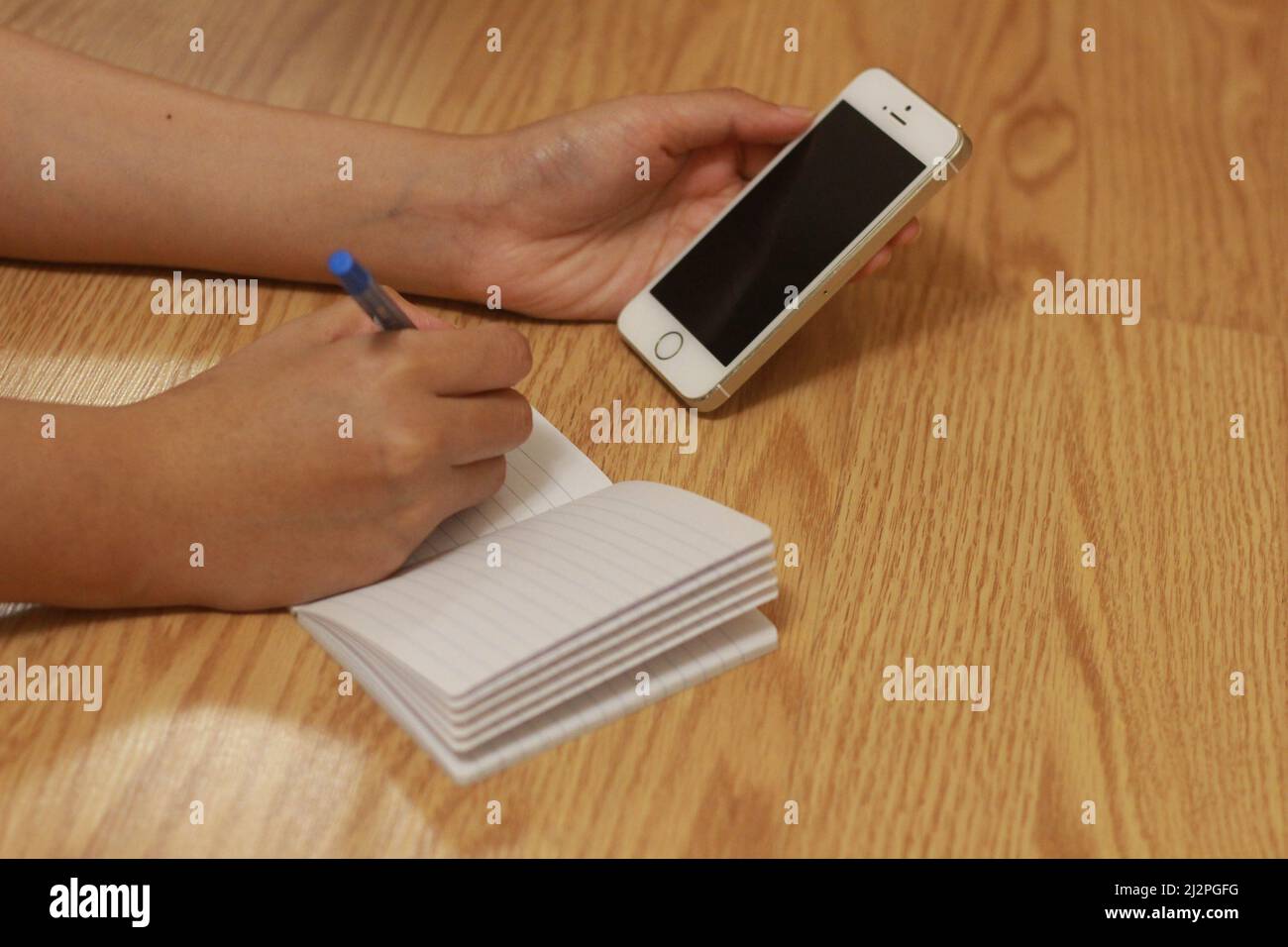 writing on note pad, note book and pen on table Stock Photo - Alamy