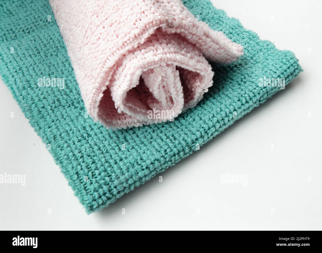 Close-up of two microfiber cleaning cloths, top view. Lying flat, a ...