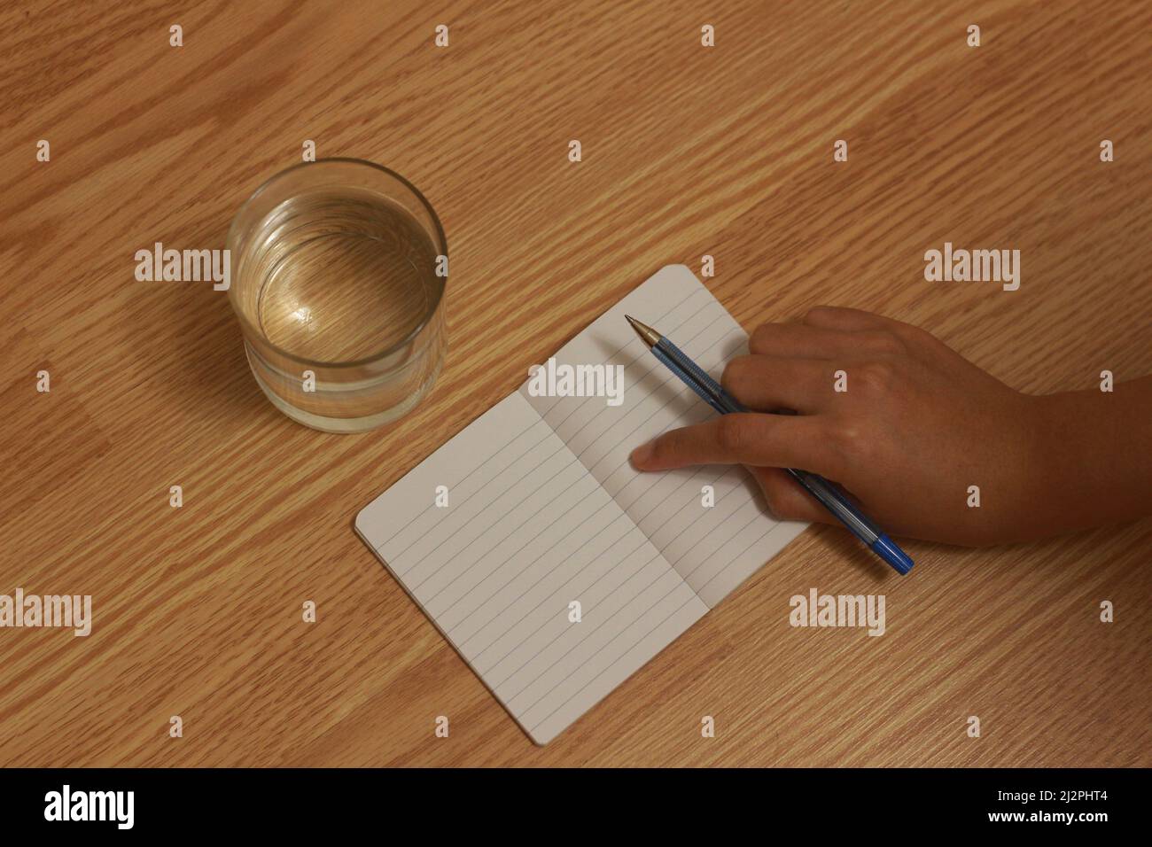 writing on note pad, note book and pen on table Stock Photo - Alamy
