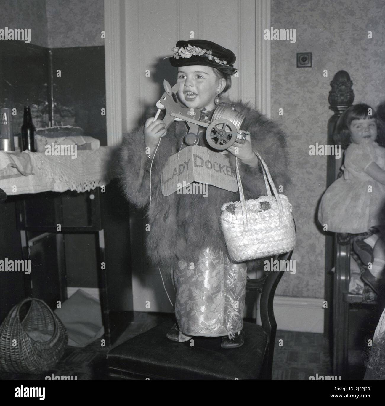 1961, historical, in a shiny dress, fur top, fancy hat, jewellery and ...