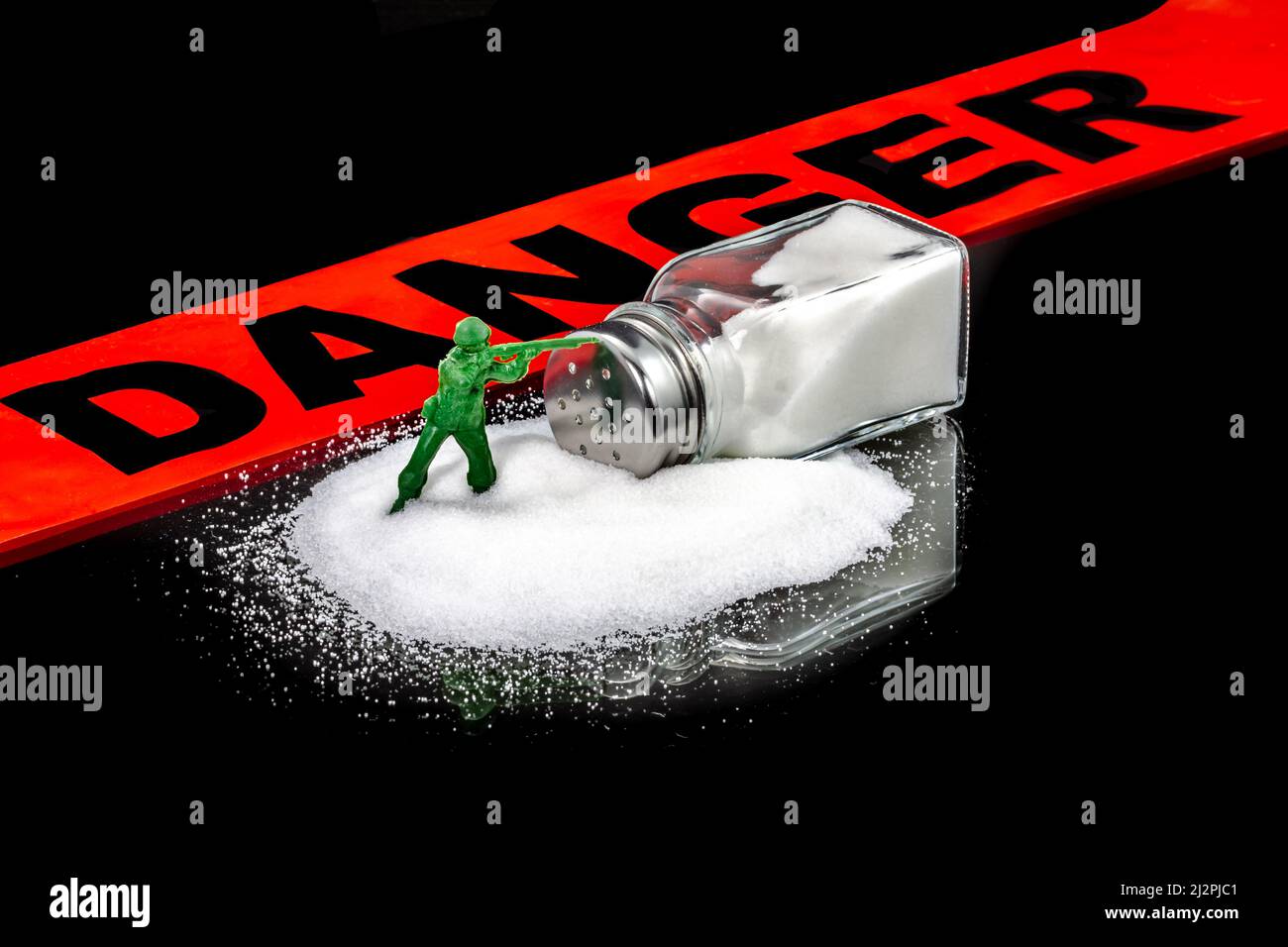 Soldier pointing his gun to a salt shaker with red danger sign Stock ...