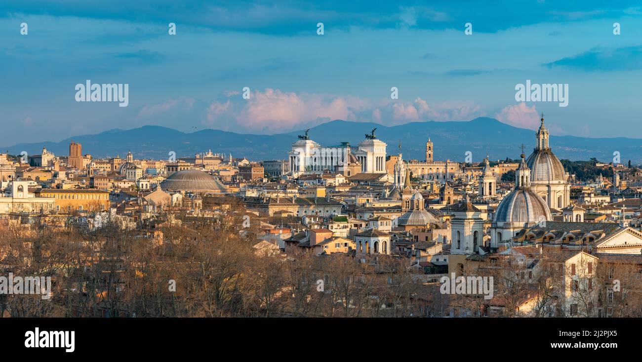A picture of the landmarks and rooftops of Rome at sunset Stock Photo ...