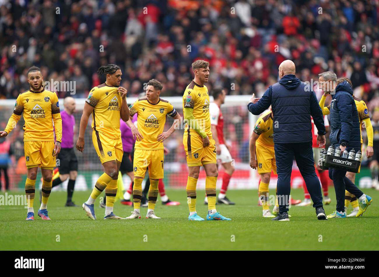 Sutton United manager Matt Gray talks to players before the start of ...