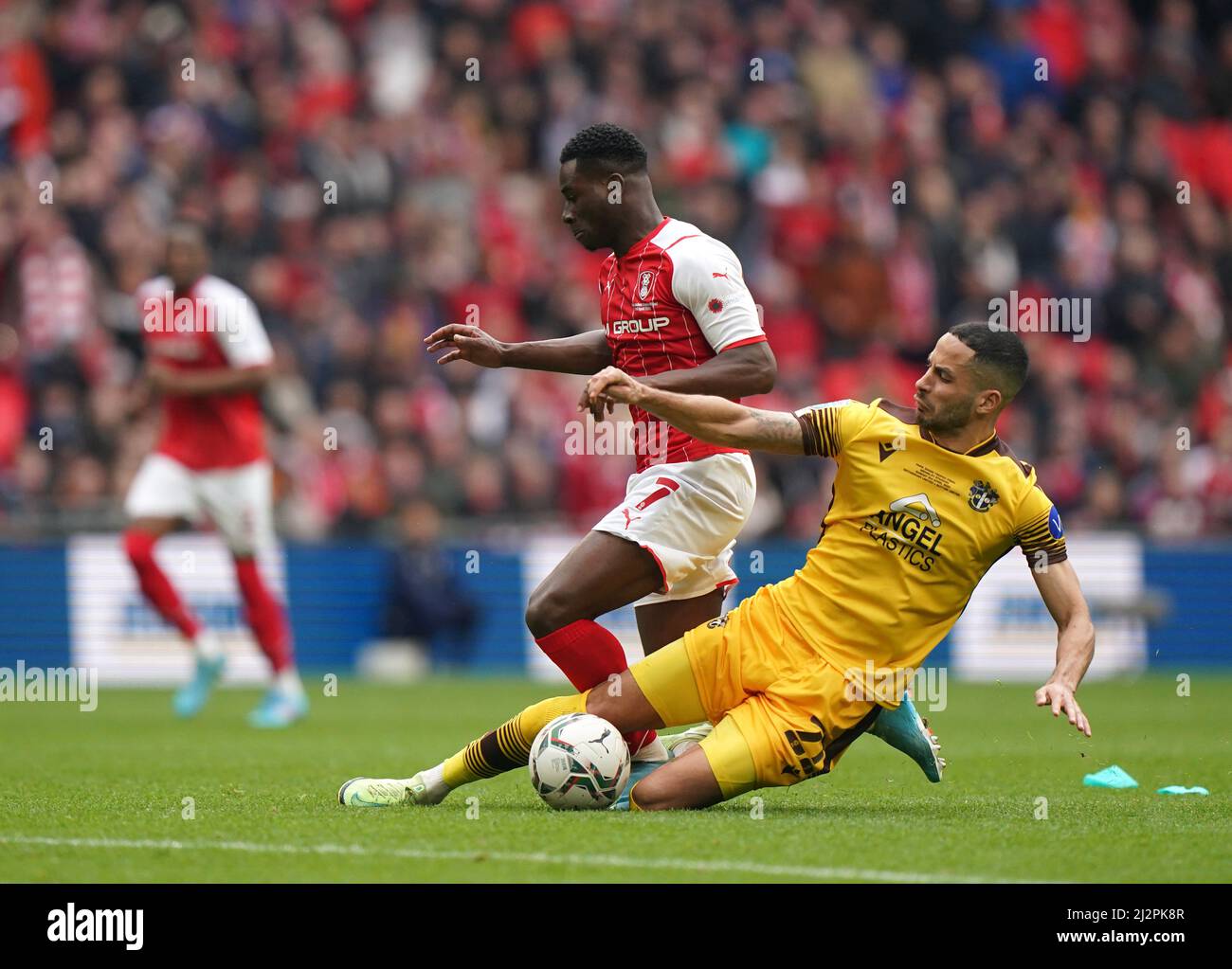 Sutton United's Joe Kizzi (right) challenges Rotherham United's Jordi ...