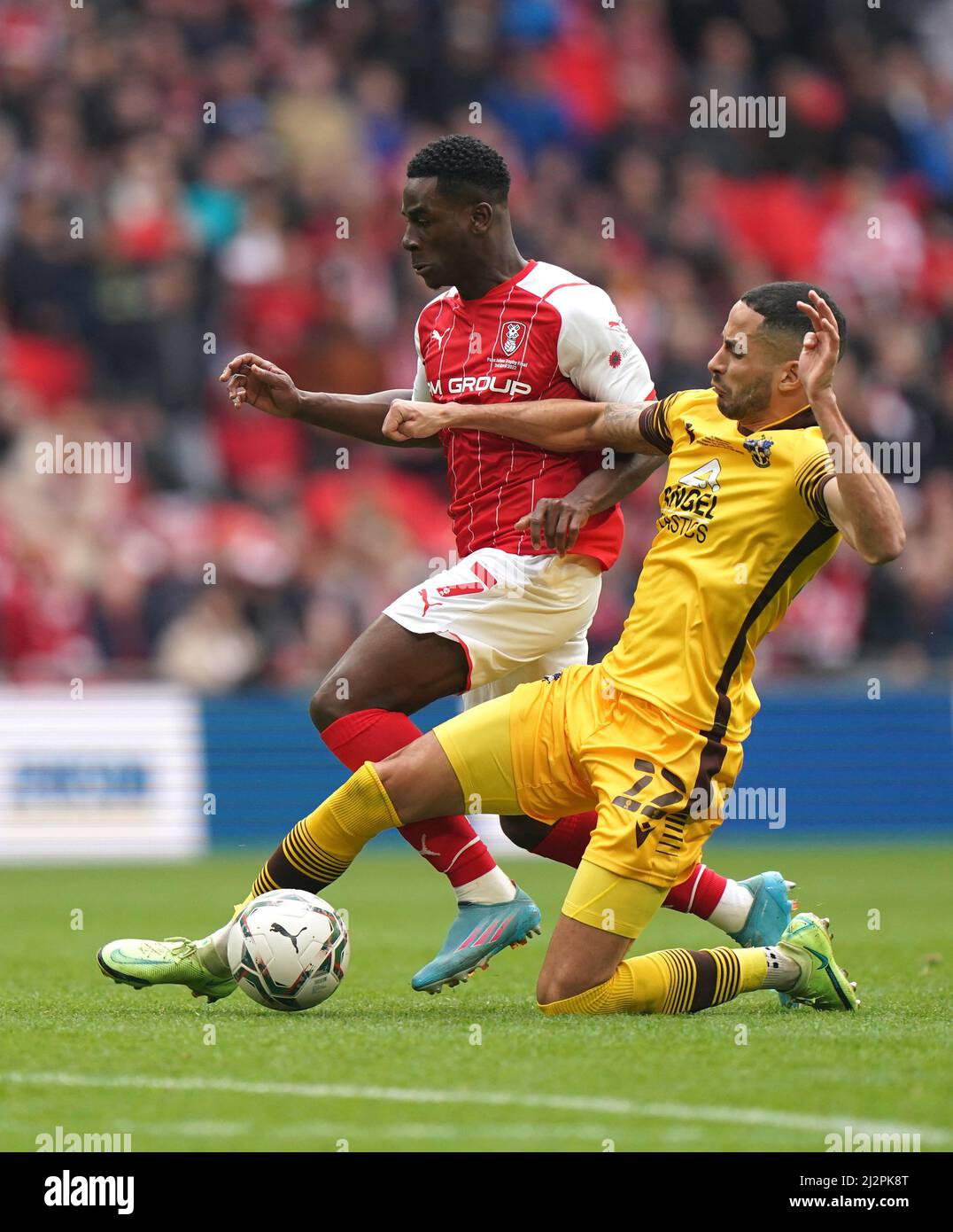 Sutton United's Joe Kizzi (right) challenges Rotherham United's Jordi ...