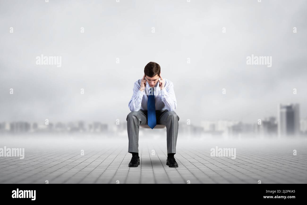 Businessman sitting on an office chair Stock Photo - Alamy