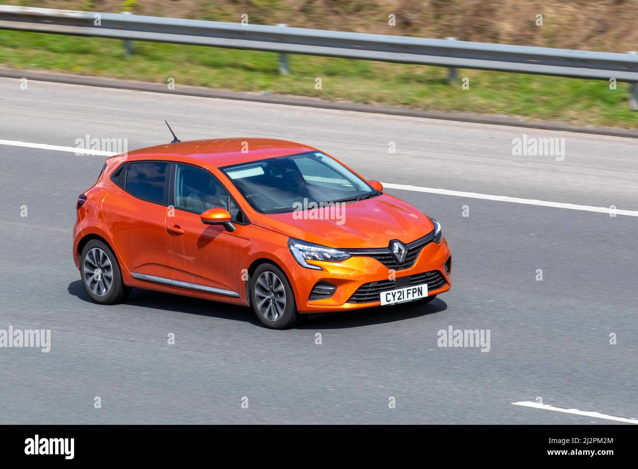 2021 orange Renault Clio DCi driving on the M61 motorway, Manchester ...