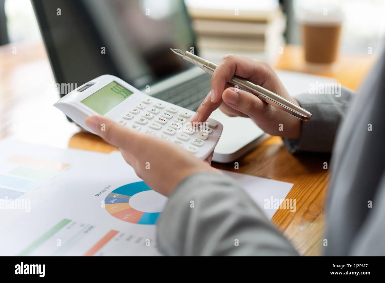 Business analyst concept the accountant using a calculator to figure ...