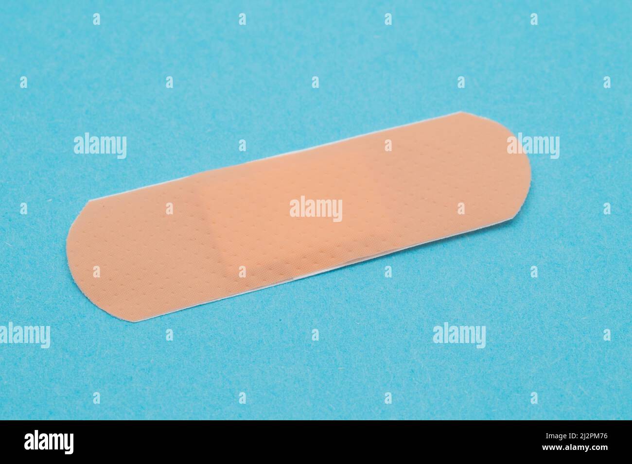 medical plaster on a blue background Stock Photo - Alamy