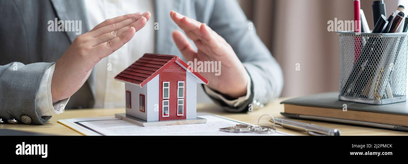 Insurance concept the property dealer presenting the modern model of ...