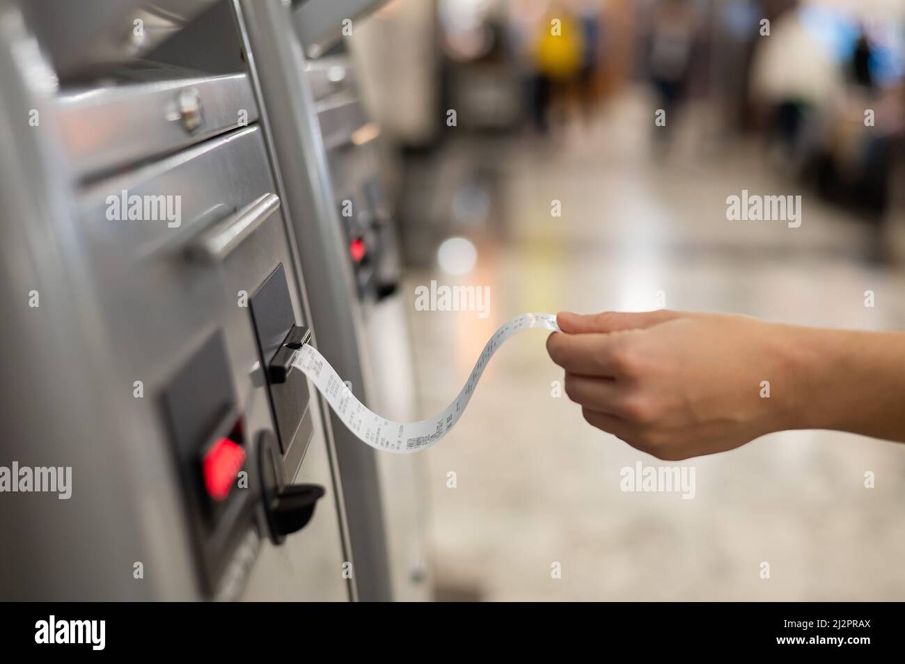 A woman takes a train ticket from a self-service ticket office Stock ...
