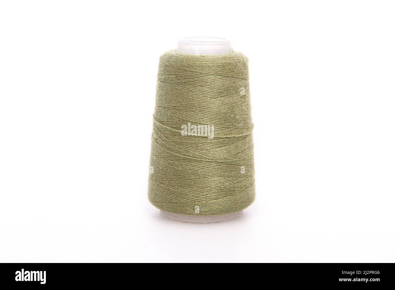 Green spool of thread isolated on white background. Skein of woolen ...
