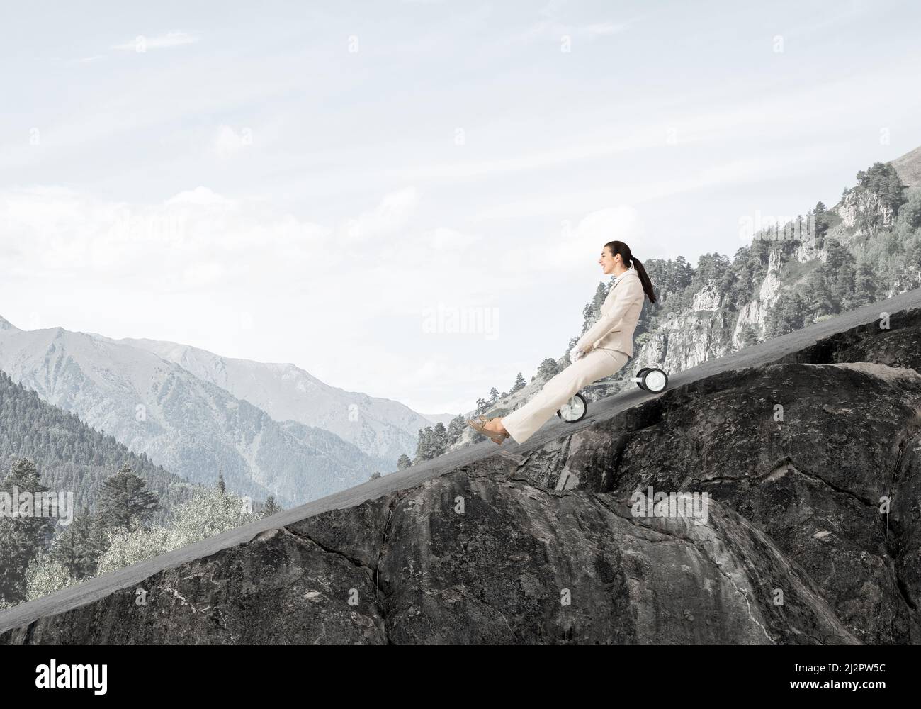 Beautiful happy woman riding downhill Stock Photo - Alamy