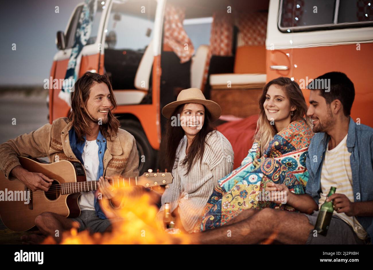 Friends around the flame is always fun. Cropped shot of a group of ...